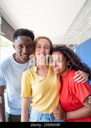 High school students having fun with colored smoke bombs while walking ...