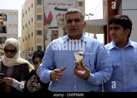 Adam Rajab, second left, the son of jailed human rights activist Nabeel ...