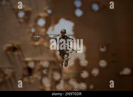 A U.S. Army soldier walks while firing his weapon during The Best ...