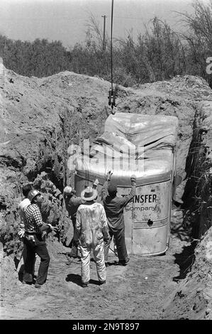 Officials remove a truck buried at a rock quarry in Livermore, Calif ...