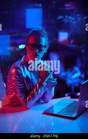 Neon metaverse futuristic concept. pensive trendy 40 years old woman ...