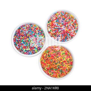 Colorful sprinkles in bowls on white background, top view ...