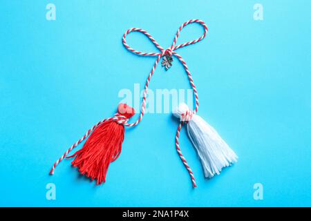Traditional martisor on light blue background. Beginning of spring ...
