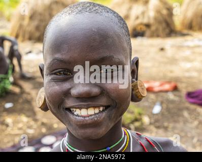 Mursi People Children in National Costumes in the Tribe Village Stock ...
