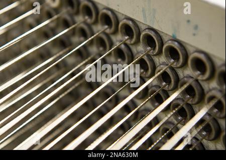 Strained cables pull out from holes of machine tool in shop Stock Photo ...