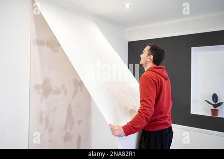 Repair the house with their own hands. The guy is ripping the old ...