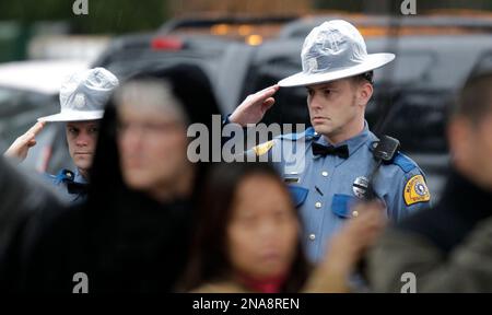 A procession of law-enforcement vehicles makes its way over the Tacoma ...