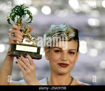 Italian singer Emma holds her trophy as she is carried by Italian show ...
