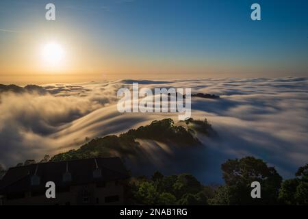 Layers of surging clouds are very spectacular. Sunset behind the mountains. The sea of clouds ...