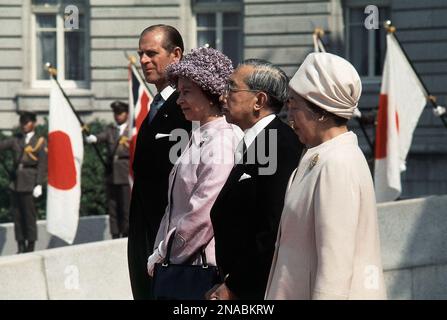 Queen Elizabeth II and Emperor Hirohito of Japan drive in an open ...