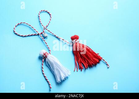 Traditional martisor on light blue background, top view with space for ...