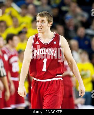 Indiana guard Jordan Hulls looks to pass in front of Iowa guard Matt ...