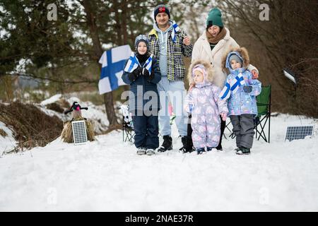 Finnish family with Finland flags on a nice winter day. Nordic ...