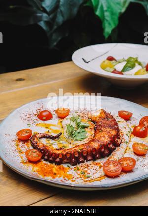 Octopus tentacle gourmet serving in a French restaurant Stock Photo - Alamy