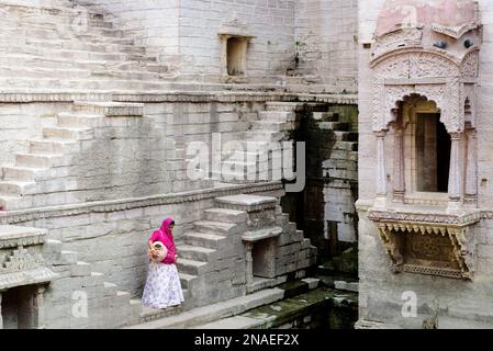 Woman collecting water from step well Stock Photo - Alamy