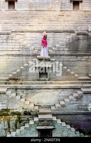 Woman collecting water from step well Stock Photo - Alamy