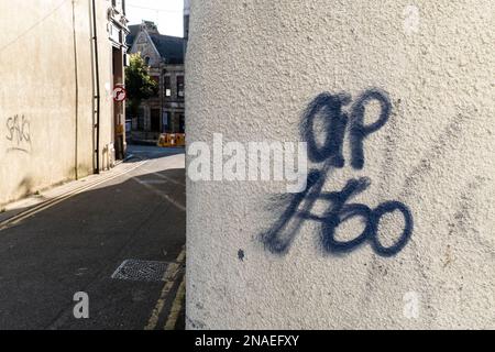 Ugly graffiti tag sprayed over a wall in Newquay town centre in ...