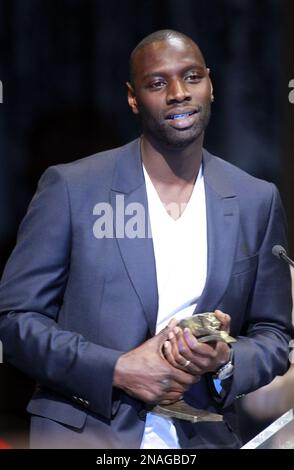 French Actor Omar Sy shows his trophy after being awarded with an Honor ...