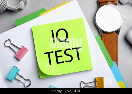 Sticky note with text IQ Test and stationery on table, flat lay Stock ...