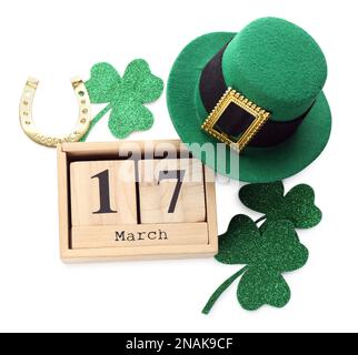 Leprechaun's hat, block calendar and St. Patrick's day decor on white ...