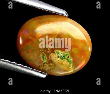 Natural gemstone noble opal on a black background Stock Photo - Alamy