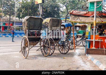 Traditional vintage wooden rickshaws parked in the street in Fariapukur ...