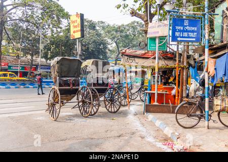 Traditional vintage wooden rickshaws parked in the street in Fariapukur ...