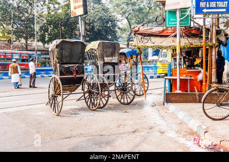 Traditional vintage wooden rickshaws parked in the street in Fariapukur ...