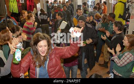 REI Employees in green welcome shoppers to the REI (Recreational ...