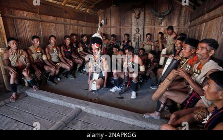Khiamniungan Naga tribe people with traditional attire drink rice beer ...