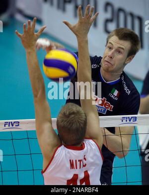 Italy's Ivan Zaytsev, right, spikes the ball against during Sebia's ...