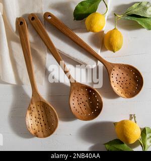 wooden spoons with lemons on white marble Stock Photo - Alamy