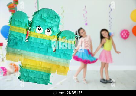 Bright festive pinata hanging indoors at birthday party Stock Photo - Alamy