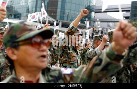 South Korean war veterans cheer during a ceremony to mark the 56th ...