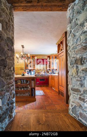 Island with stone and inlaid ceramic tile top with pine wood cabinets ...