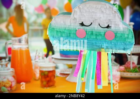 Bright festive pinata hanging indoors at birthday party Stock Photo - Alamy