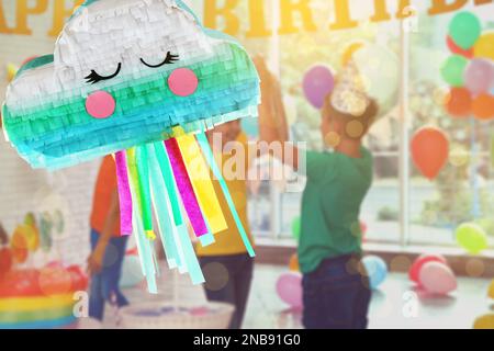 Bright festive pinata hanging indoors at birthday party Stock Photo - Alamy