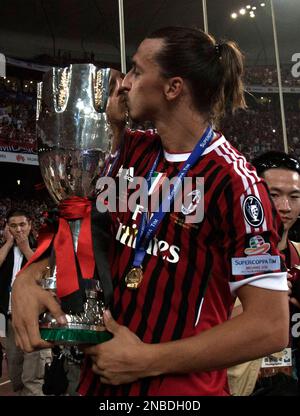 AC Milan's forward Zlatan Ibrahimovic holds the Italian Super Cup ...