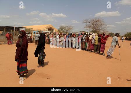 Refugees newly arrived from Somalia wait to be registered at a ...