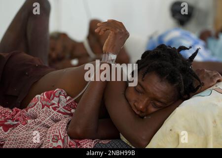 A woman suffering cholera symptoms rests at a hospital in Archaie ...