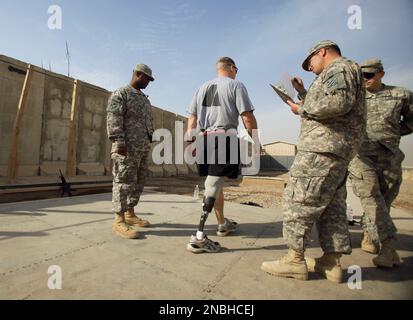 U.S. Army Maj. David Rozelle puts on a specialized prosthetic leg ...