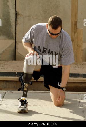 U.S. Army Maj. David Rozelle puts on a specialized prosthetic leg ...