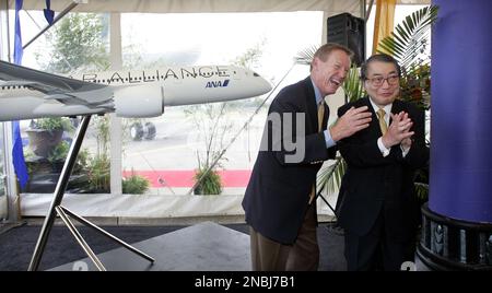Boeing CEO Alan Mulally, left, reaches to shake hands with Chinese ...