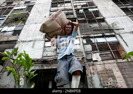 Manila, The Philippines: Resident of a poor neighborhood living in huts ...