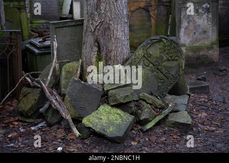 Broken headstones on graves in churchyard at historic 11th century St ...