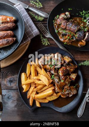 Fried sausage and french fries with sauce Stock Photo - Alamy