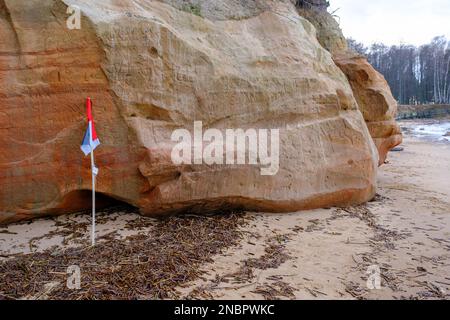 Beautiful in all weathers, colorful sandstone cliffs with fishing flags ...