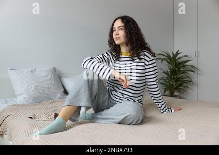 Young beautiful woman wearing pajama and sleep mask over pink isolated ...