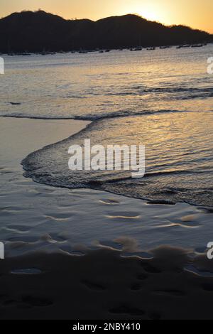 Wave patterns on water covered beach on Playa Coco, Costa Rica, at ...