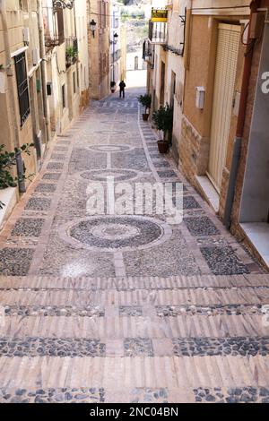 Relleu, Alicante, Spain- February 5, 2023: Narrow pebbled street and ...